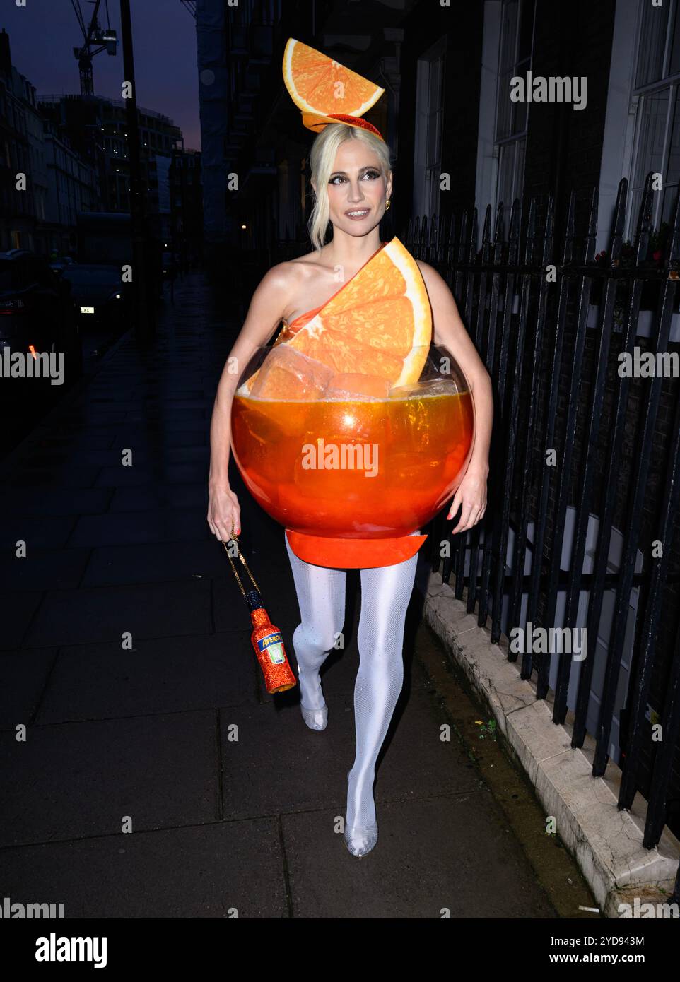 EDITORIAL USE ONLY Pixie Lott wears an Aperol Spritz Halloween costume ...