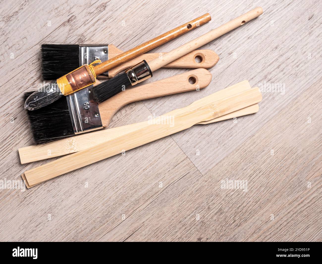 Clean brushes and sticks for mixing paint on a wooden floor Stock Photo ...