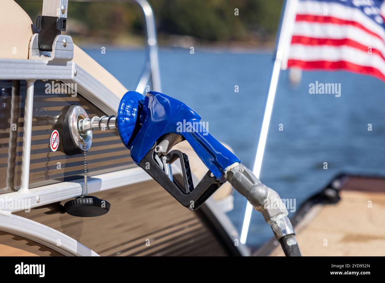 Boat refueling at marina. Gas pump nozzle filling pontoon party boat ...