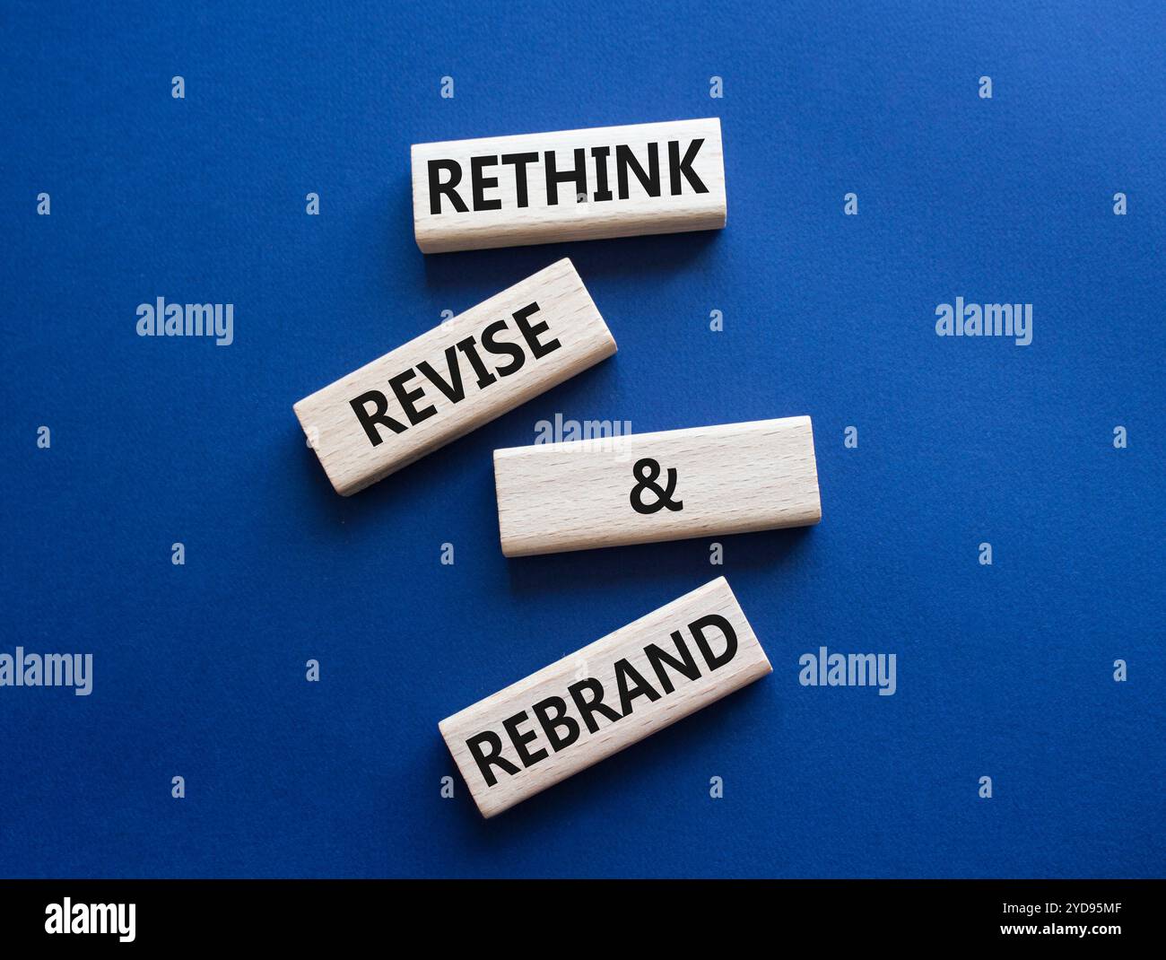 Rethink Revise and Rebrand symbol. Wooden blocks with words Rethink Revise and Rebrand ...