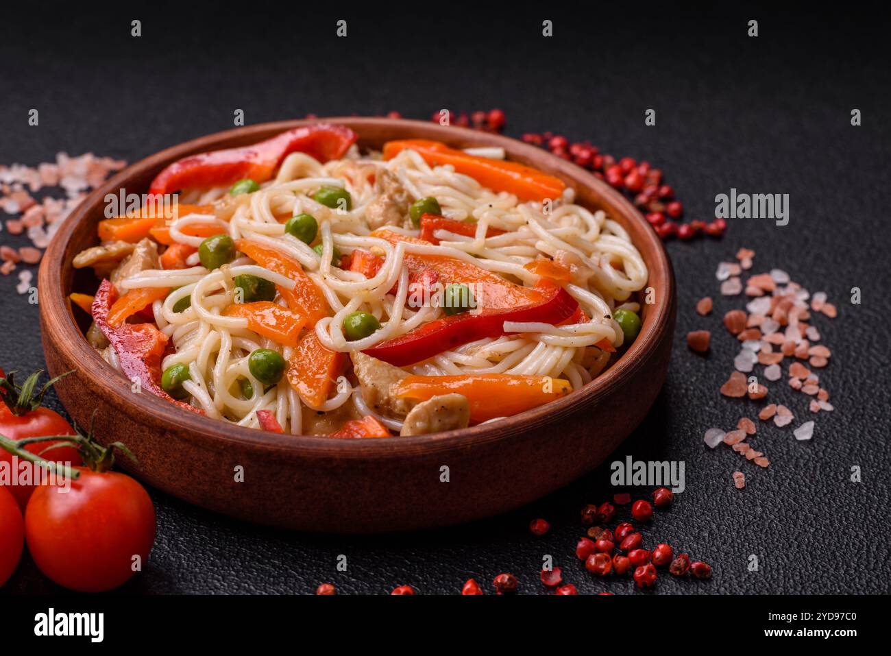 Delicious rice noodles or udon with chicken, carrots, pepper, salt ...