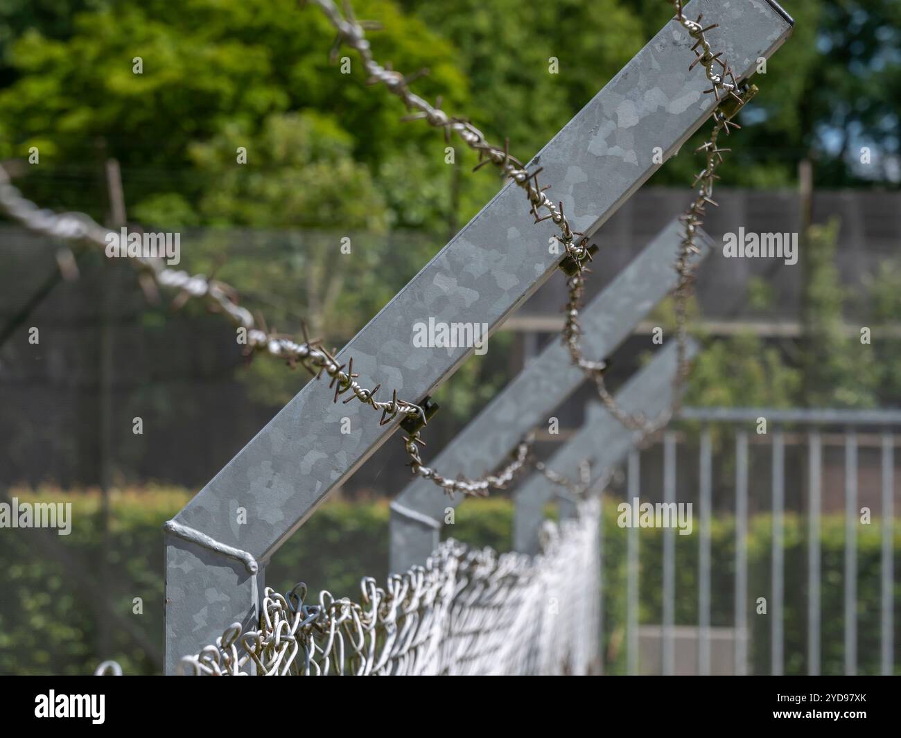 Metal fence with barbed wire Stock Photo - Alamy