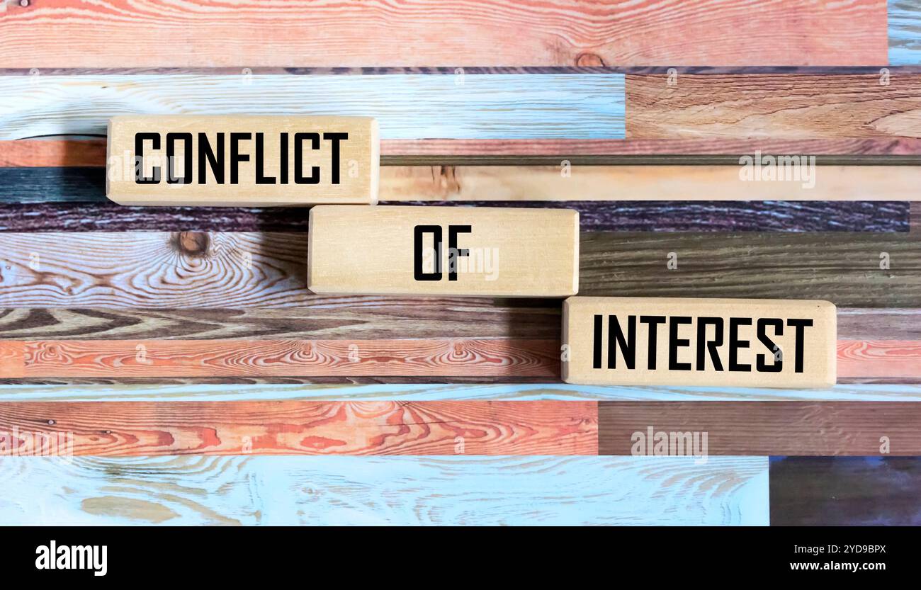 A symbol of a conflict of interest. Wooden blocks with the inscription ...