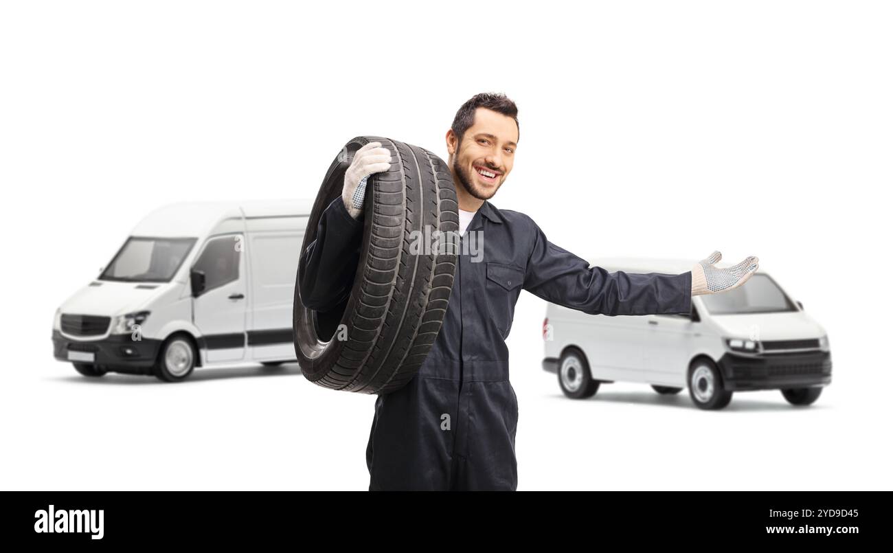 Auto mechanic with a van tire gesturing welcome isolated on white ...