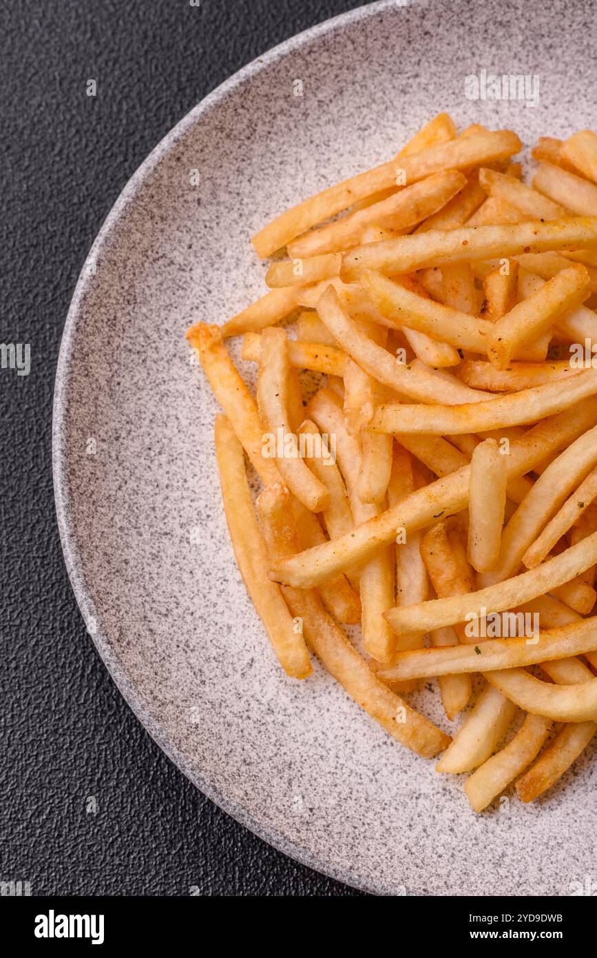 Delicious crispy golden fries with salt and spices Stock Photo - Alamy