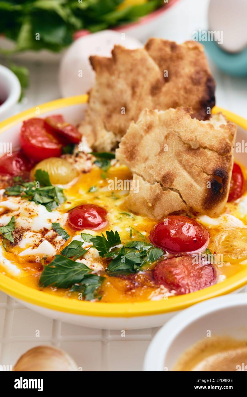 Cilbir or Turkish Eggs in white bowl. Turkish cuisine concept Stock ...