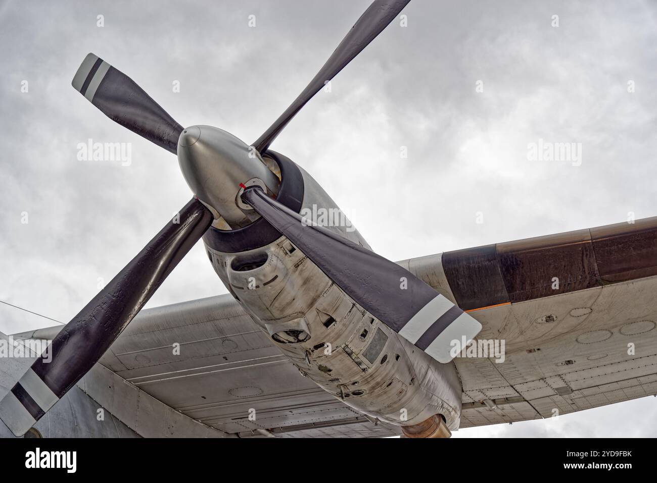 Detailed view of aircraft propeller blade against dramatic cloudy sky ...