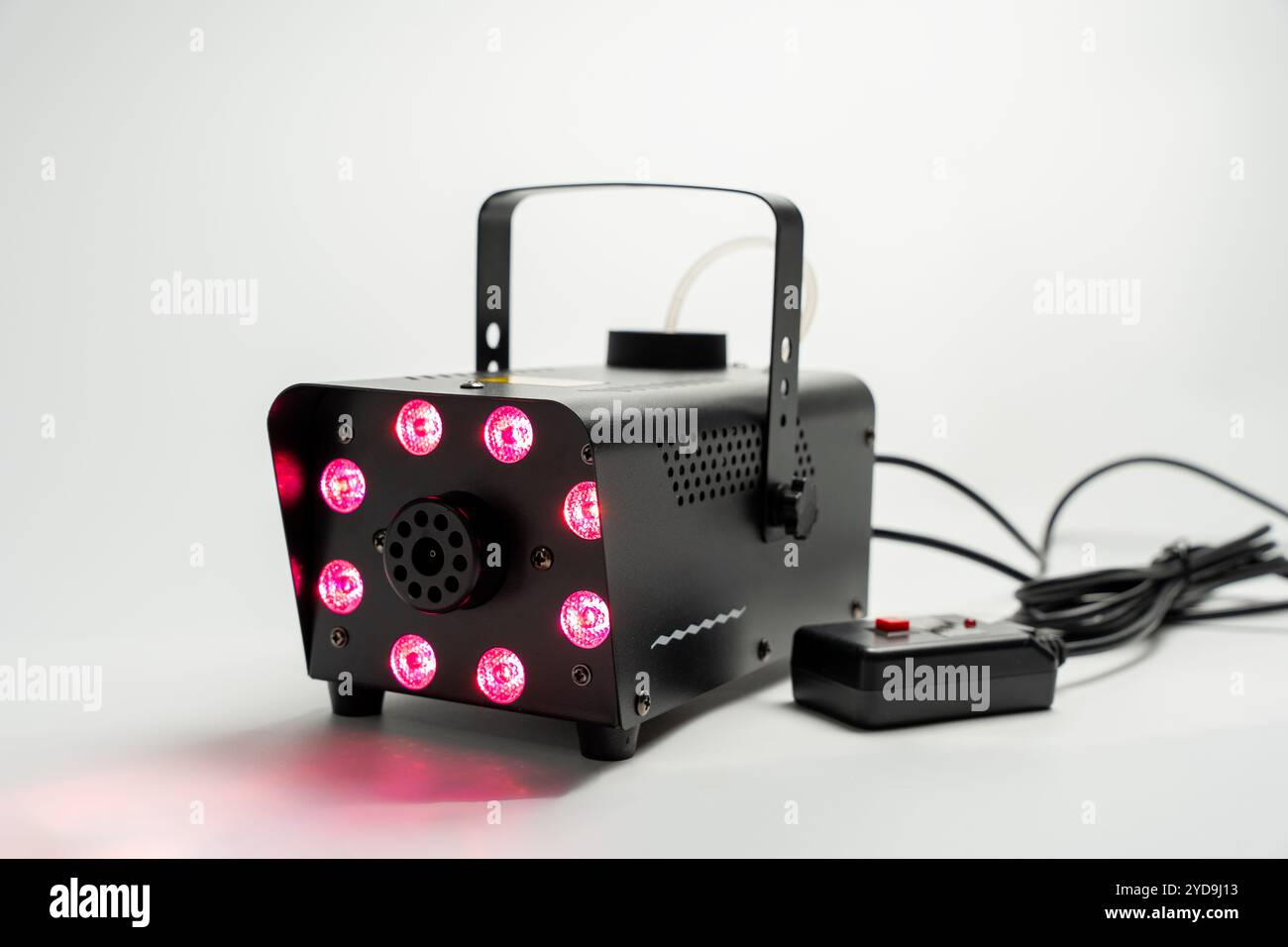 Black device with a red light. Black smoke machine connected to a power ...