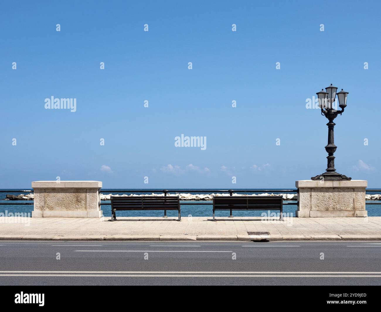 Summer view of the seaside promenade with street lamp, sea and blue sky ...