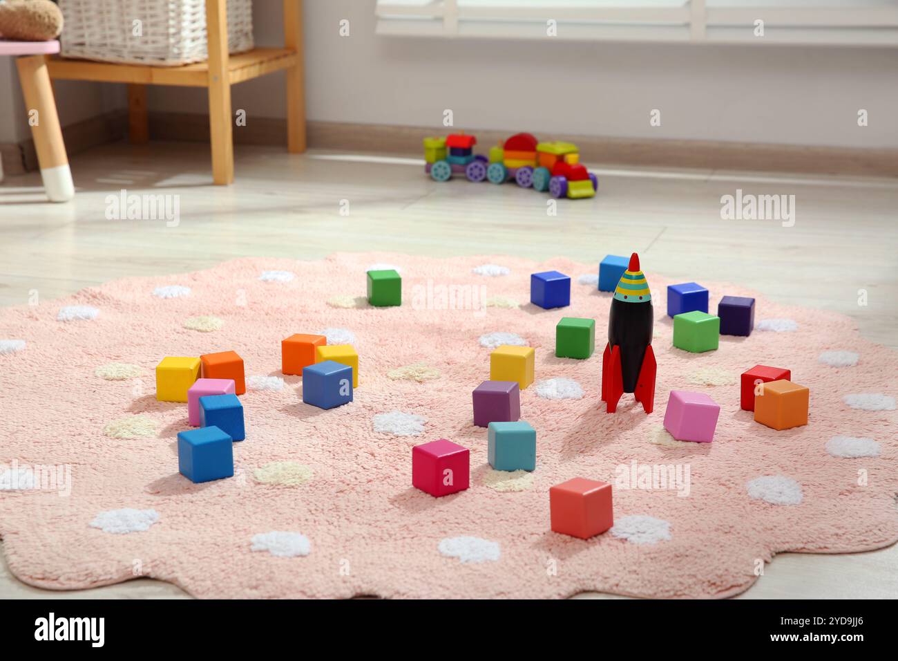 Colorful cubes and rocket toy in child's room Stock Photo - Alamy