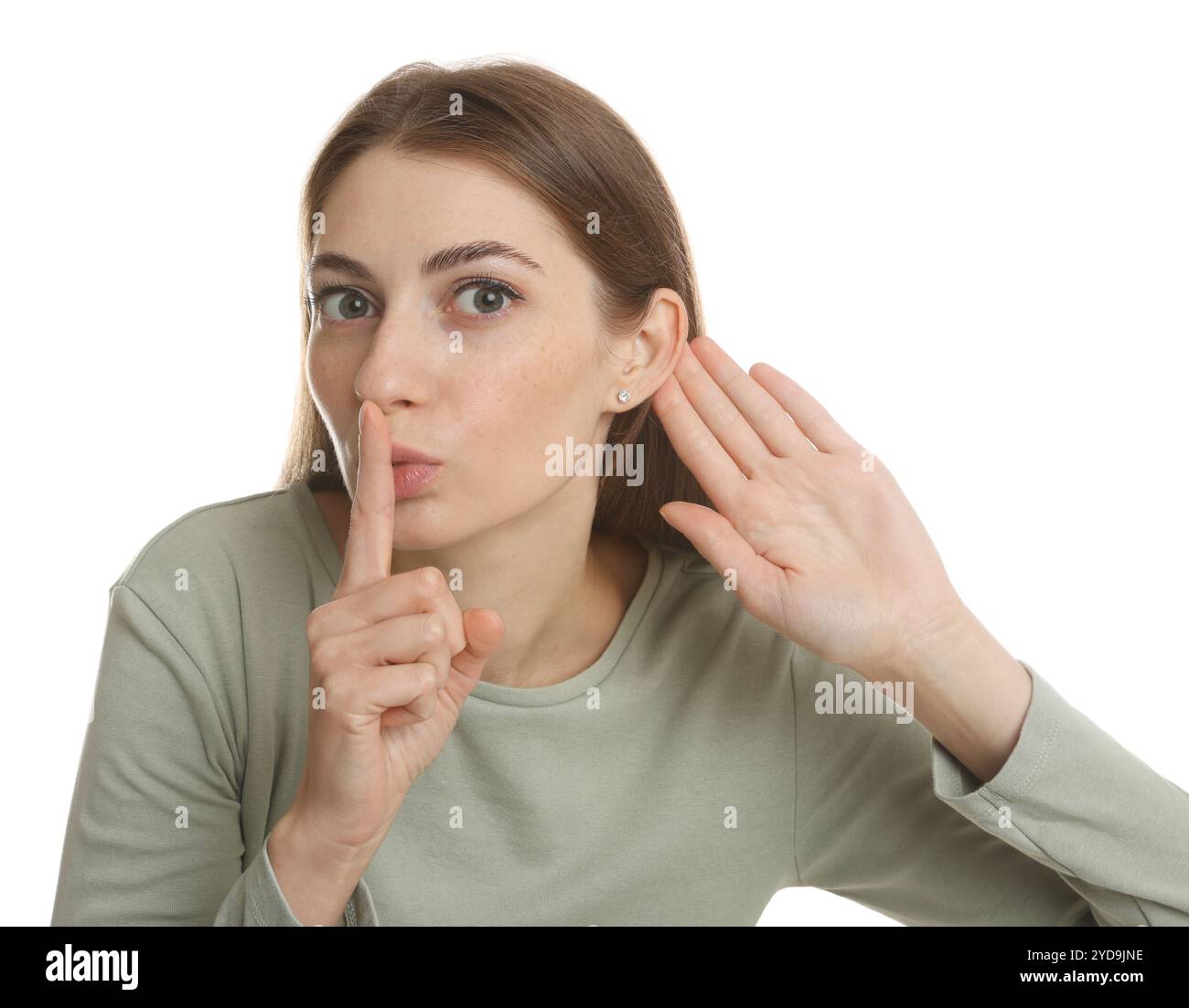 Woman showing hand to ear gesture on white background Stock Photo - Alamy