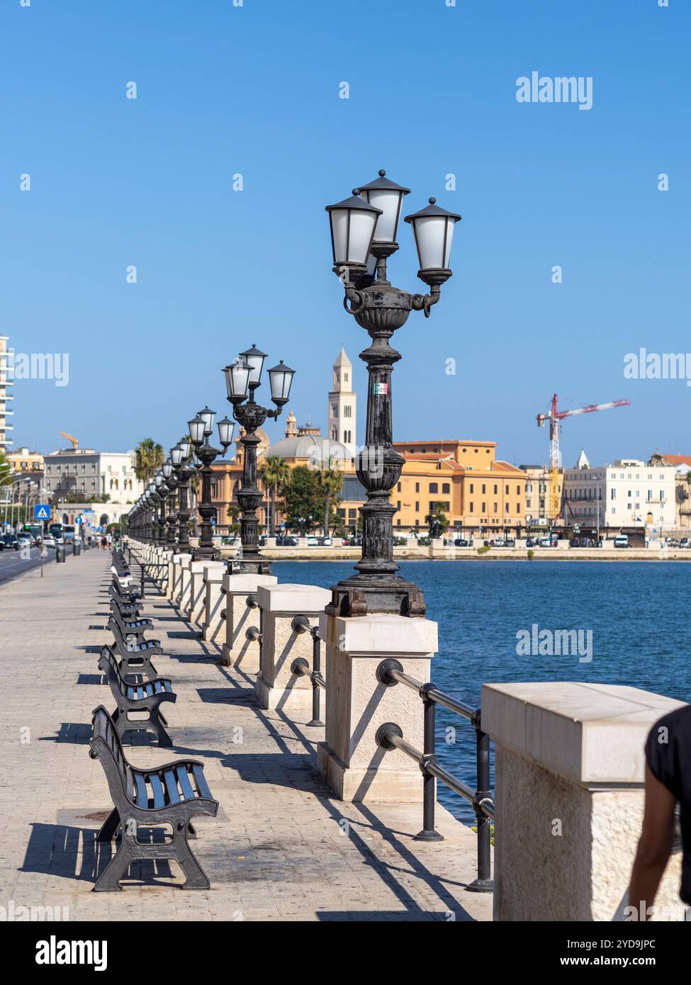 Lanterns and benches on the sea promenade in Bari, in the background ...