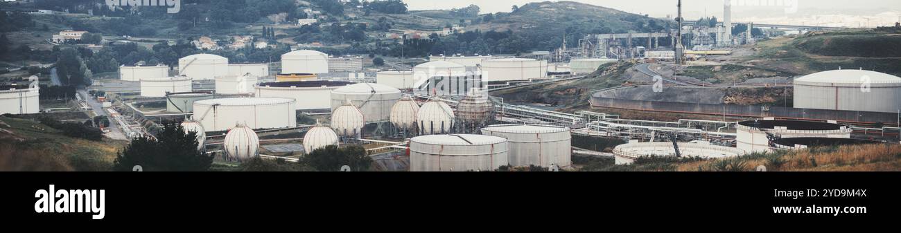 Panoramic view of an industrial oil refinery in a hilly landscape ...