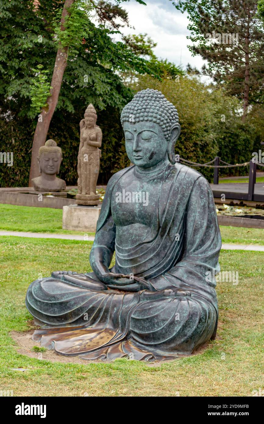 Buddha statue in a zen garden Stock Photo - Alamy