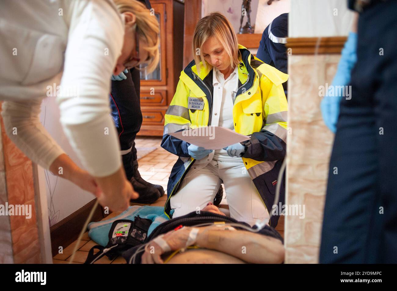 A paramedic attending to a patient in a domestic setting. Paramedics ...