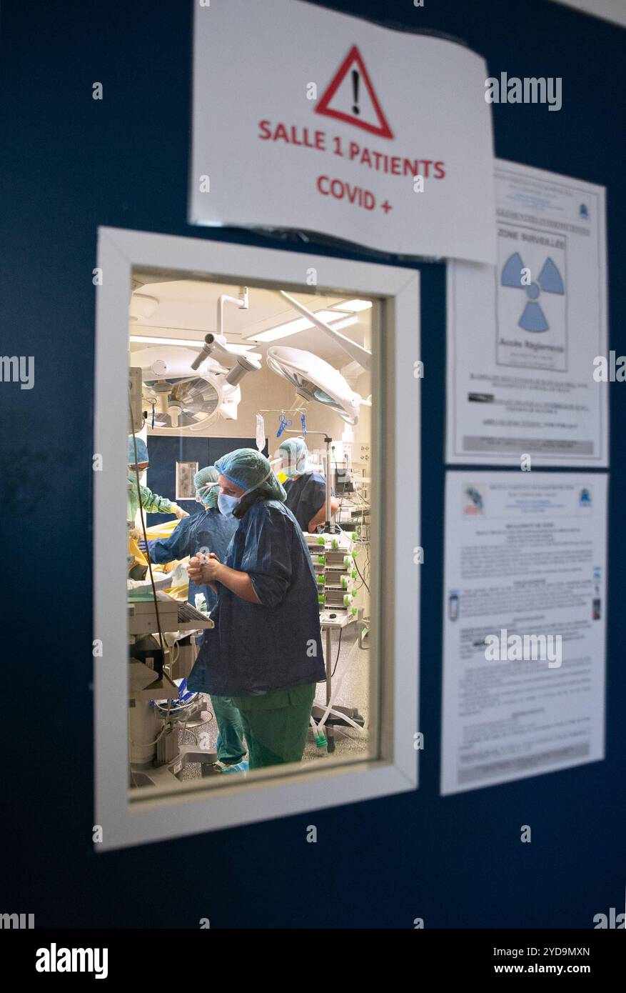 A view of a hospital operating room through a window, with medical ...