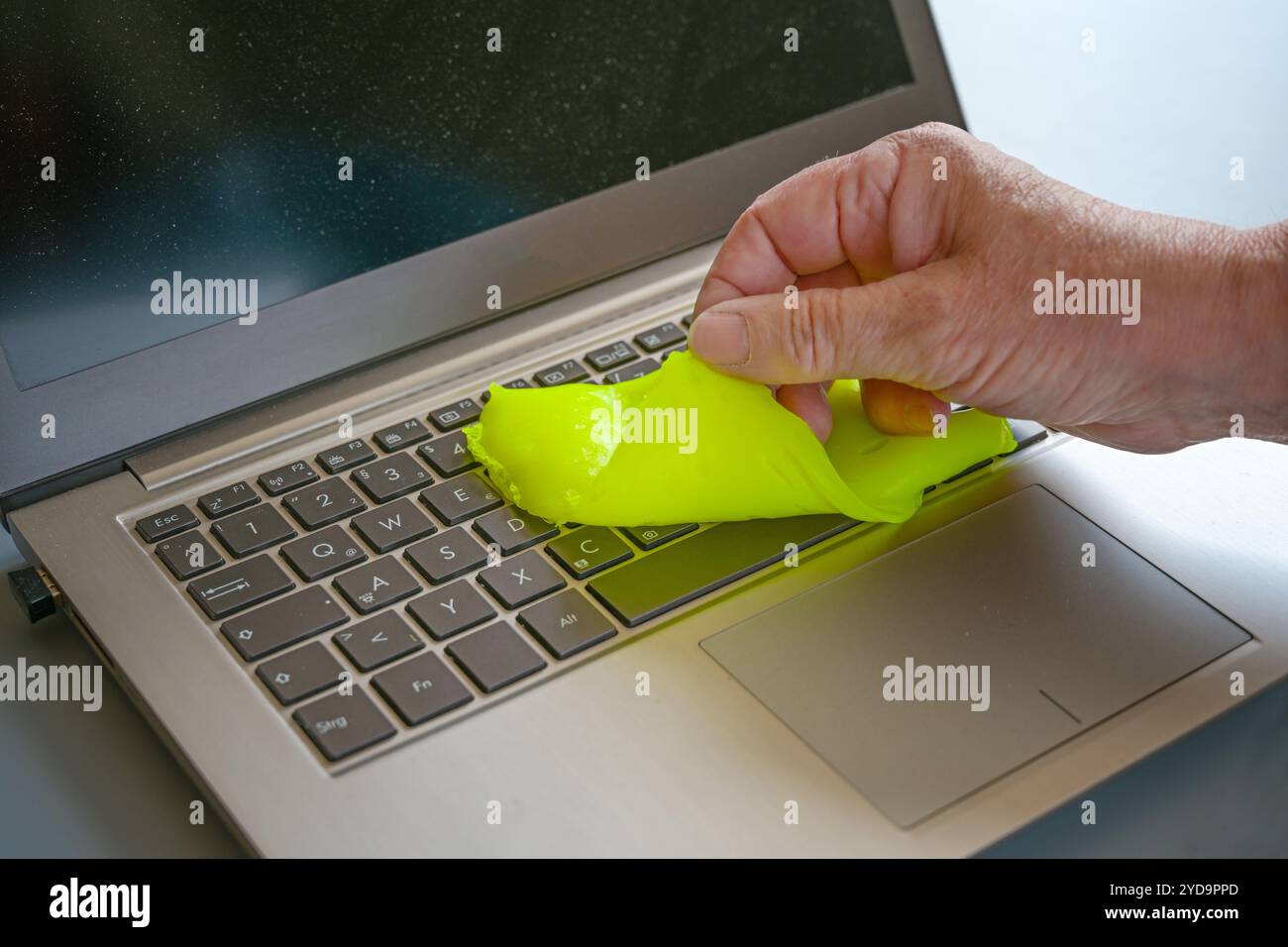 Soft yellow absorbing gel or compound, used on a laptop keyboard to ...