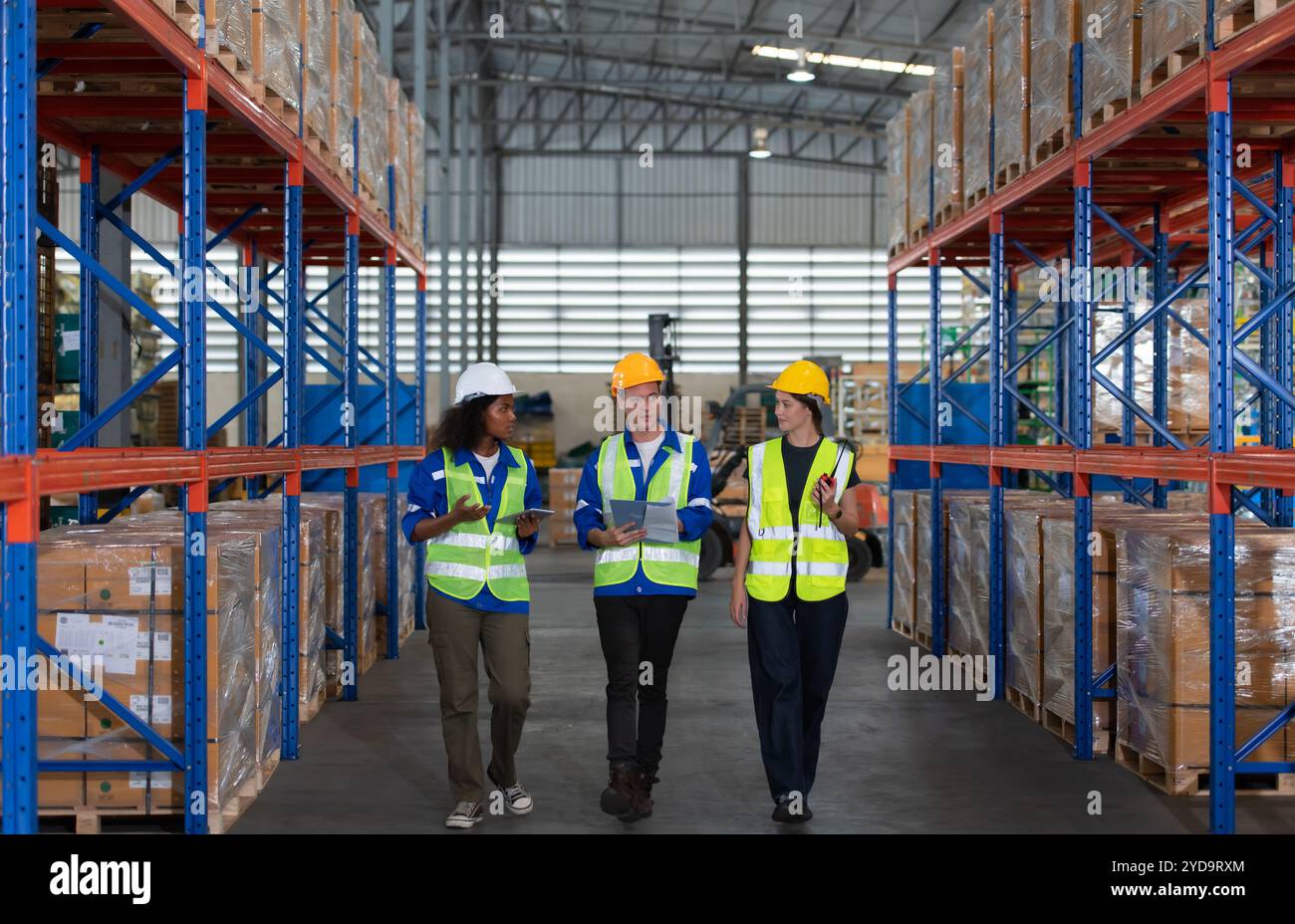 Group of employees in an auto parts warehouse, Examine auto parts that ...