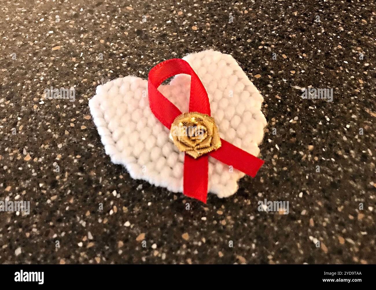 A handmade HIV/AIDS awareness pin. The red ribbon is an international ...