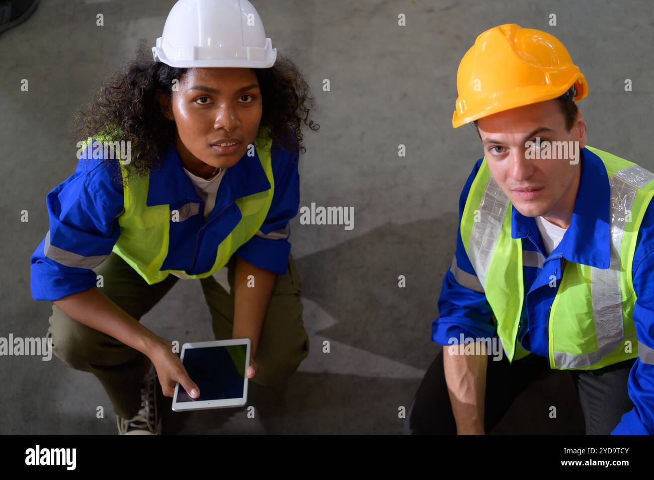 Both of employees in an auto parts warehouse, Examine auto parts that ...