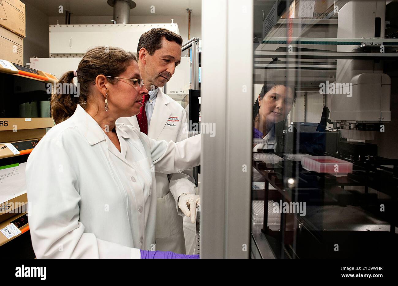 VRC scientists working with a Biomek Nxp robot, which is used to set up ...