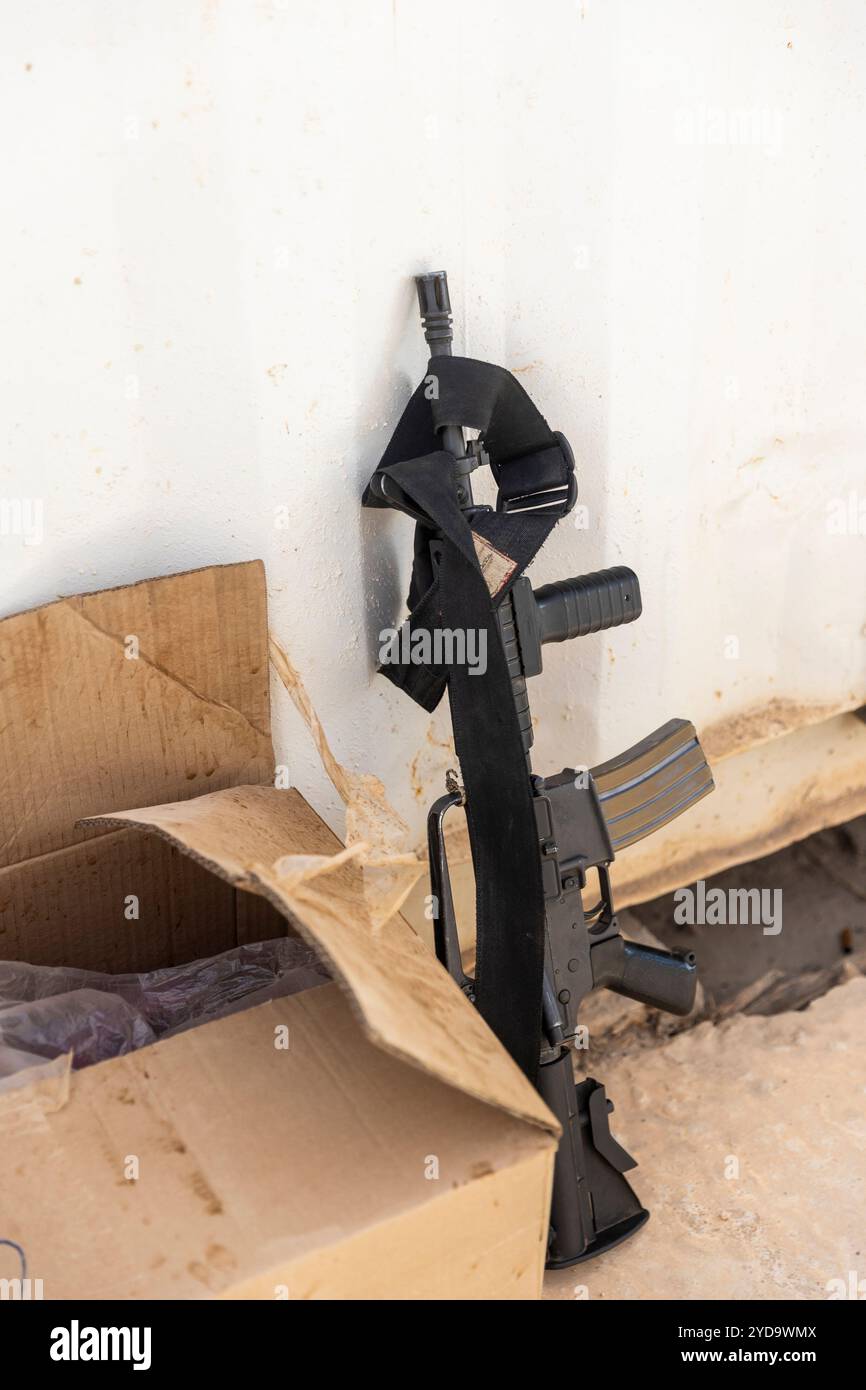 An American rifle is leaning against the wall in a soldiers' mess hall ...