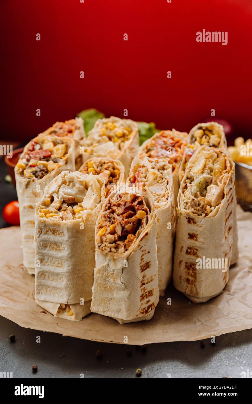 Assorted grilled wraps with diverse fillings, perfect for a party ...
