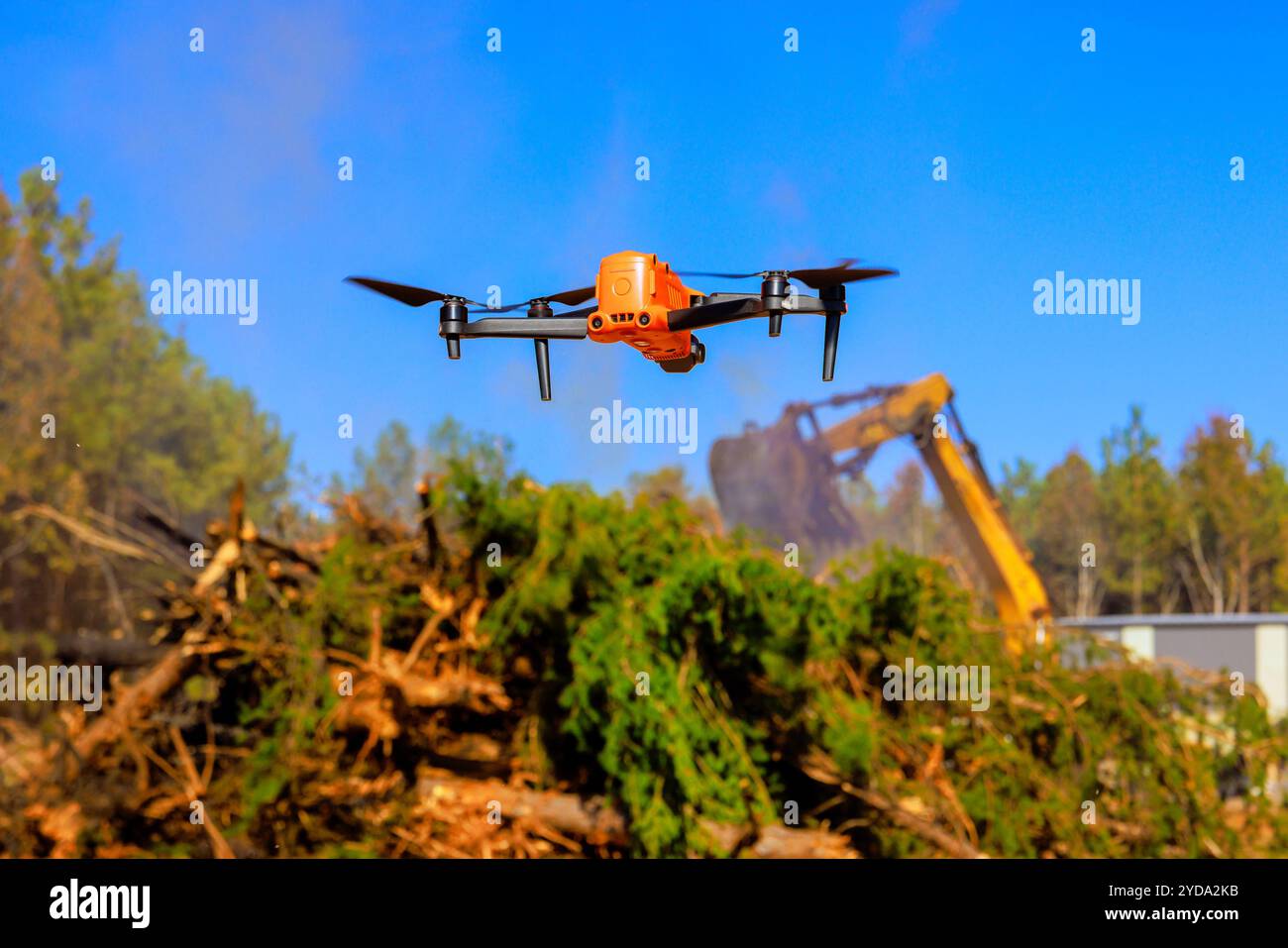 Drone is employed by an inspector to monitor tree burning during ...