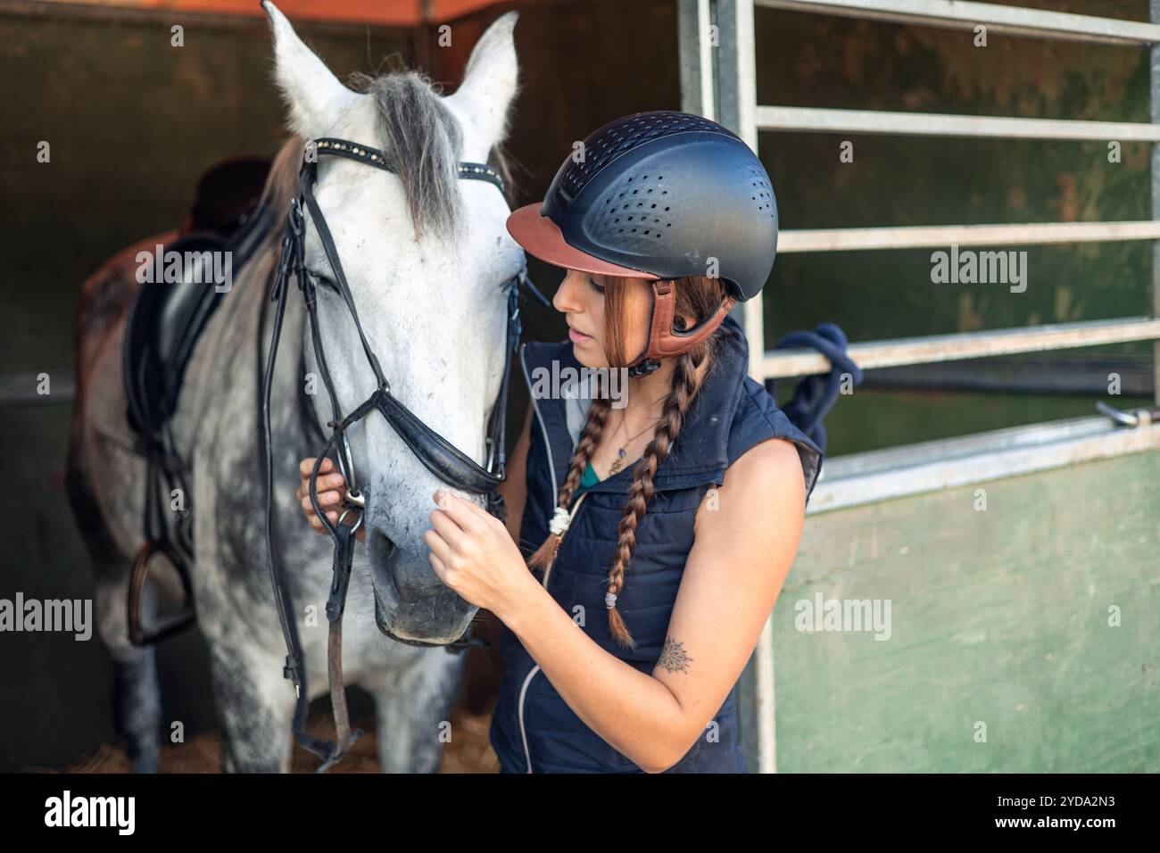 close-up image features a young equestrian wearing a helmet as she ...