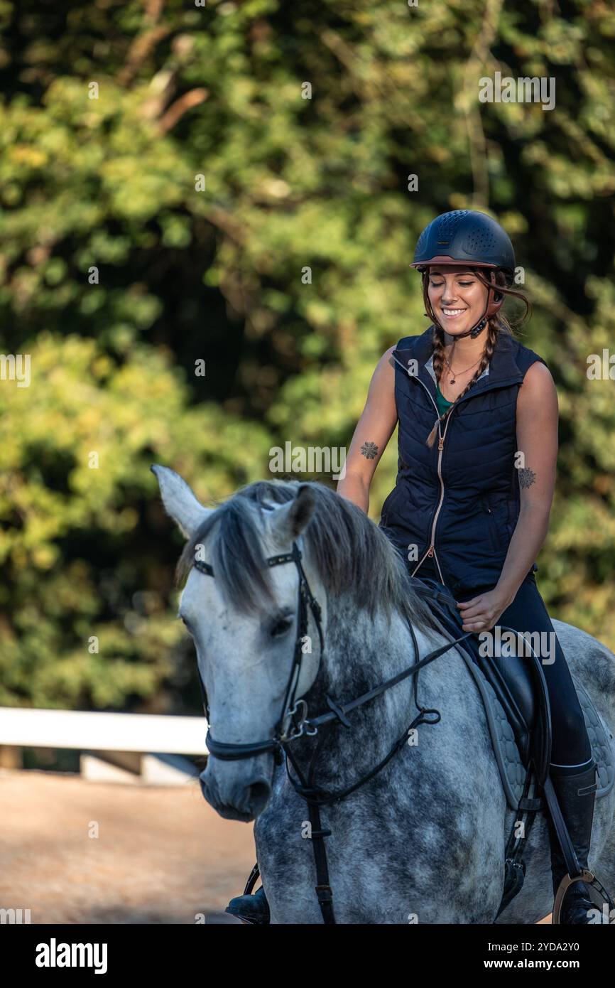 vertical serene young woman rider enjoys a calm stroll with her horse ...