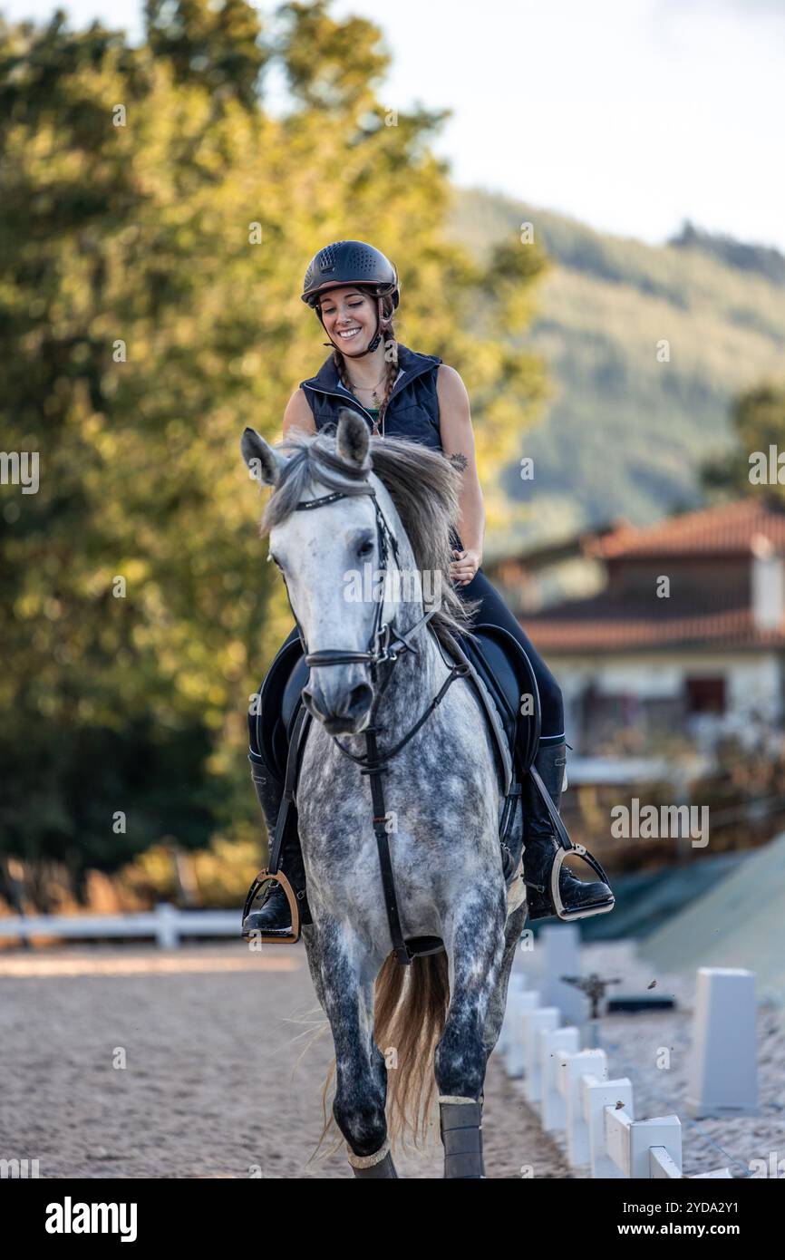 vertical joyful young woman rider smiles brightly as she rides her ...