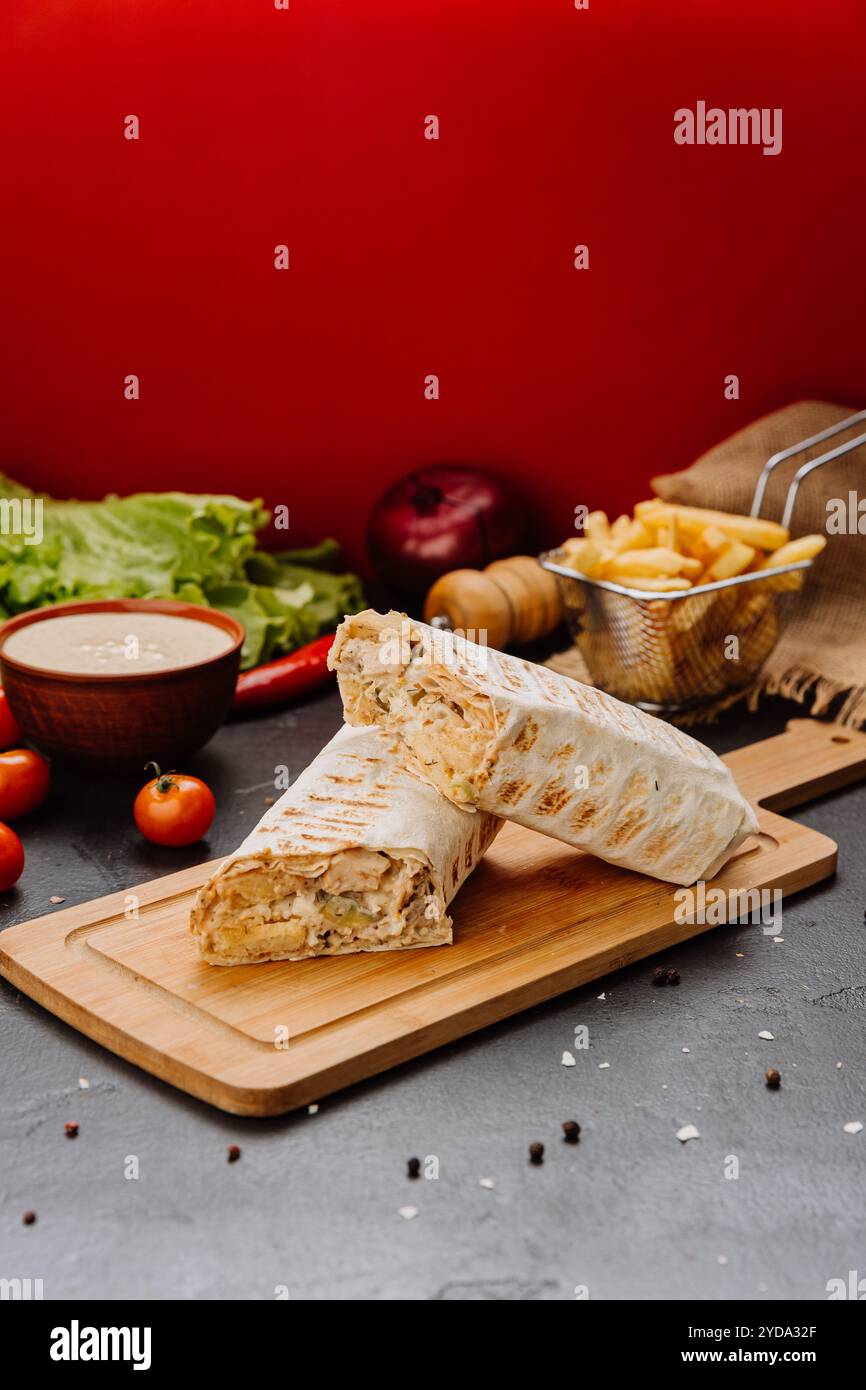Freshly grilled chicken wrap cut in half, revealing creamy filling ...