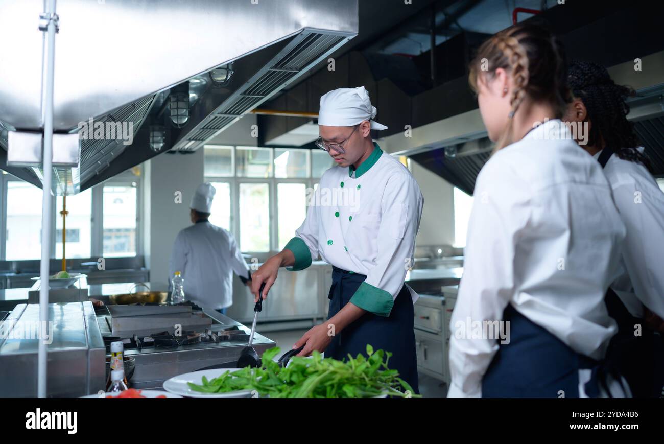Male chef teaching young woman hi-res stock photography and images - Alamy