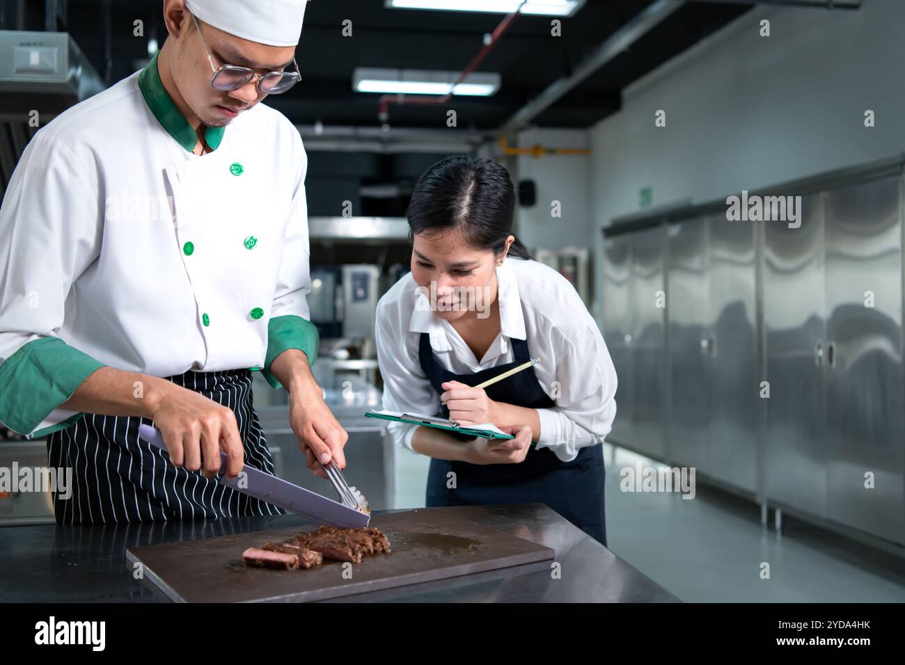 Student cooking apprentice Take notes on every step as the chef cooks ...