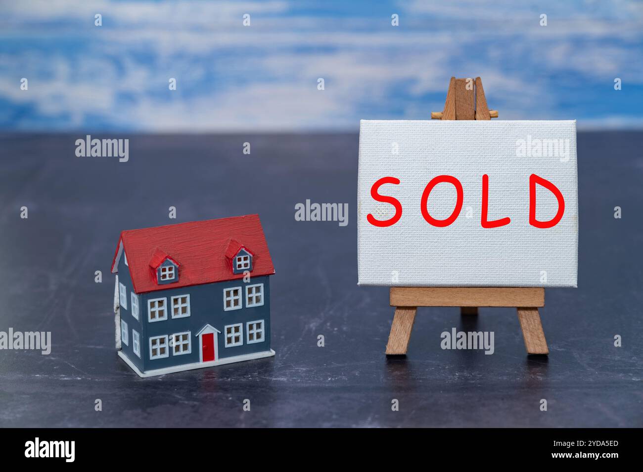 Model home with a Sold sign on a wooden easel Stock Photo - Alamy