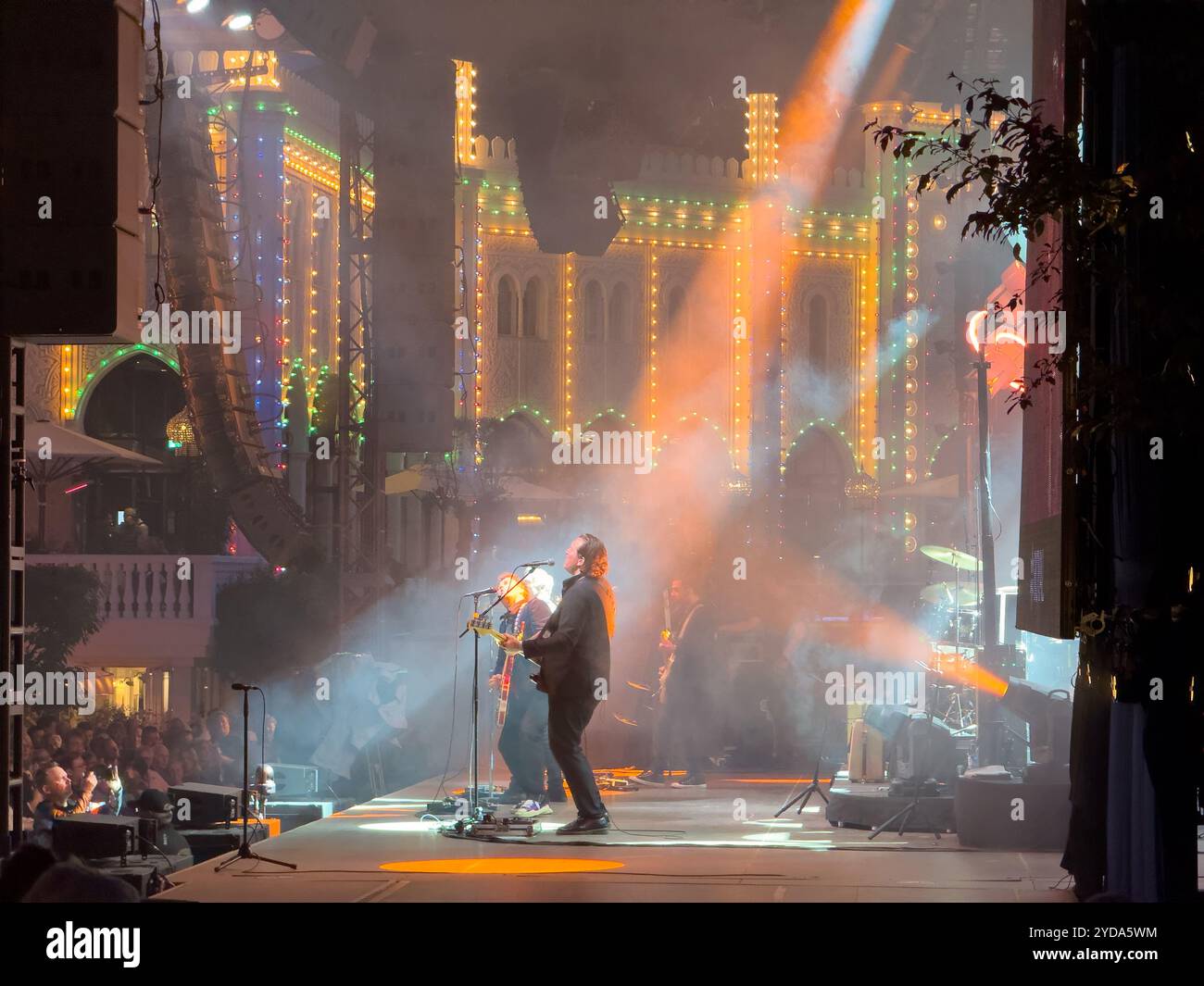 Enjoy an electrifying live concert with a vibrant backdrop and stunning ...