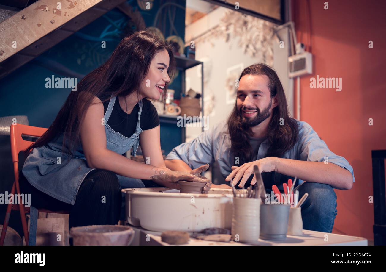 Young couples that enjoy making clay sculptures. Using pottery and ...