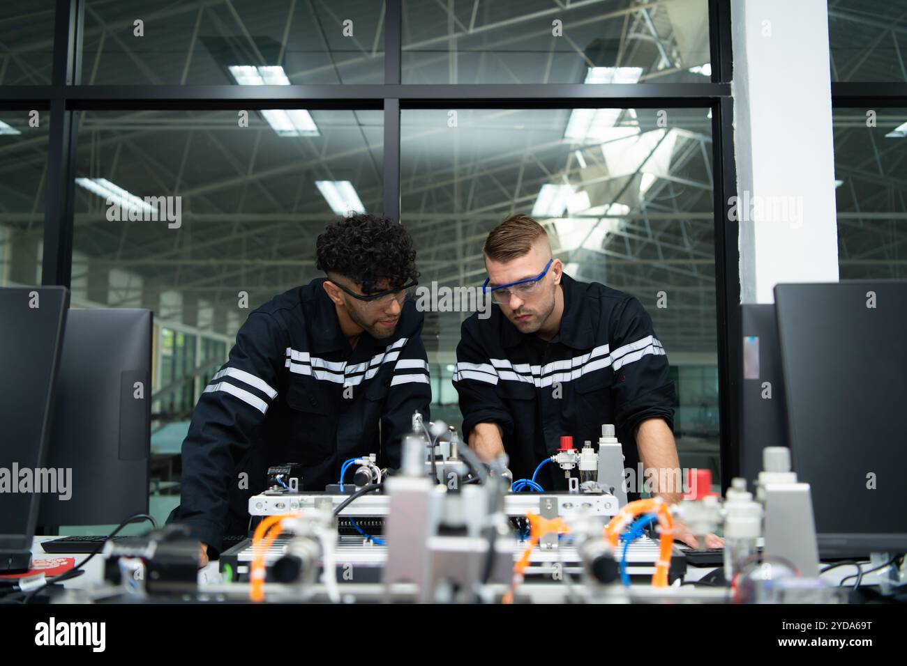 The robotic hand technology teacher is instructing new students on how to use electronic circuit ...