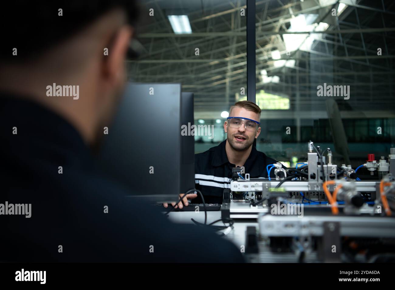 The robotic hand technology teacher is instructing new students on how ...