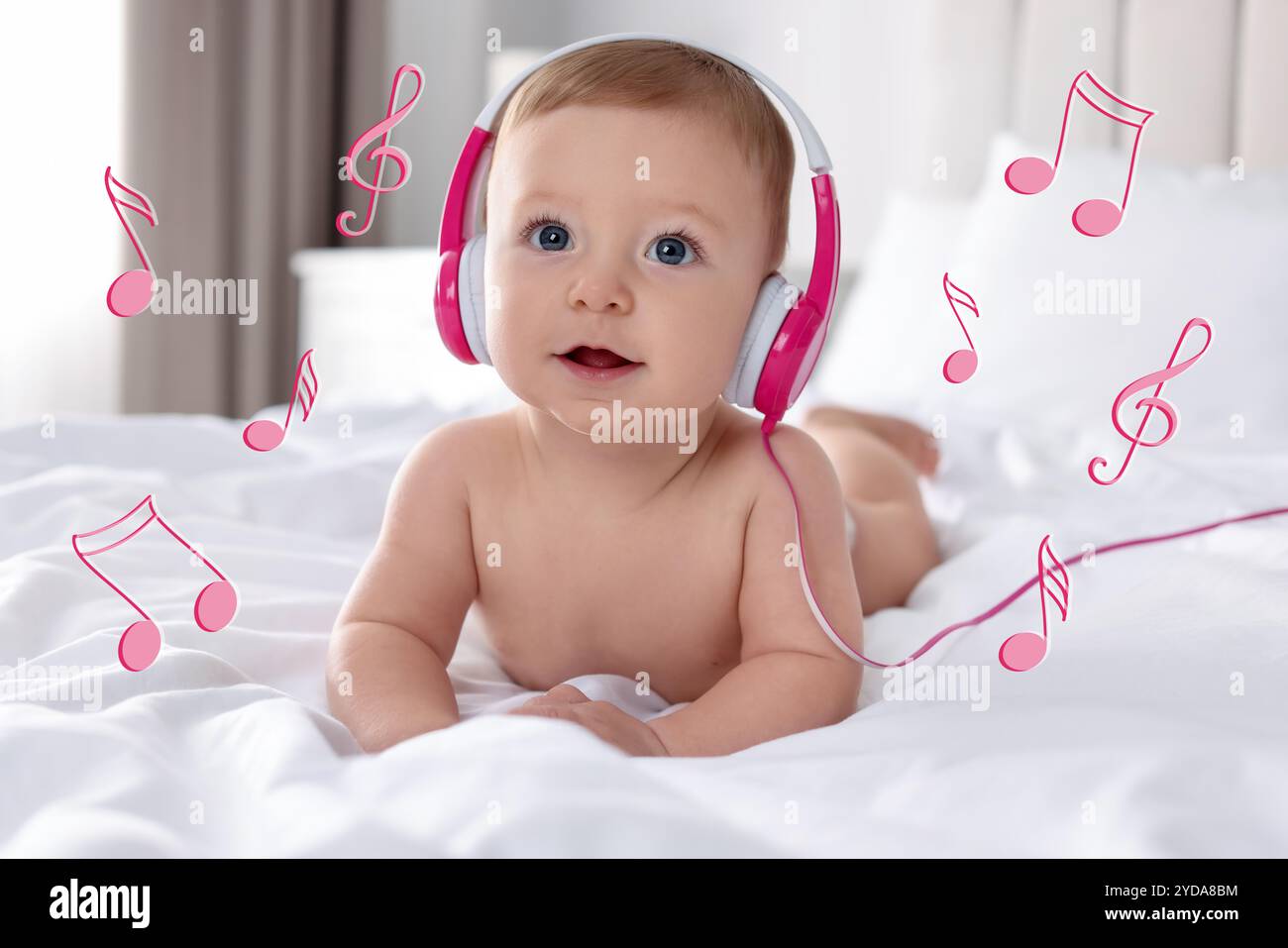 Cute little baby with headphones on bed at home. Music notes flying ...