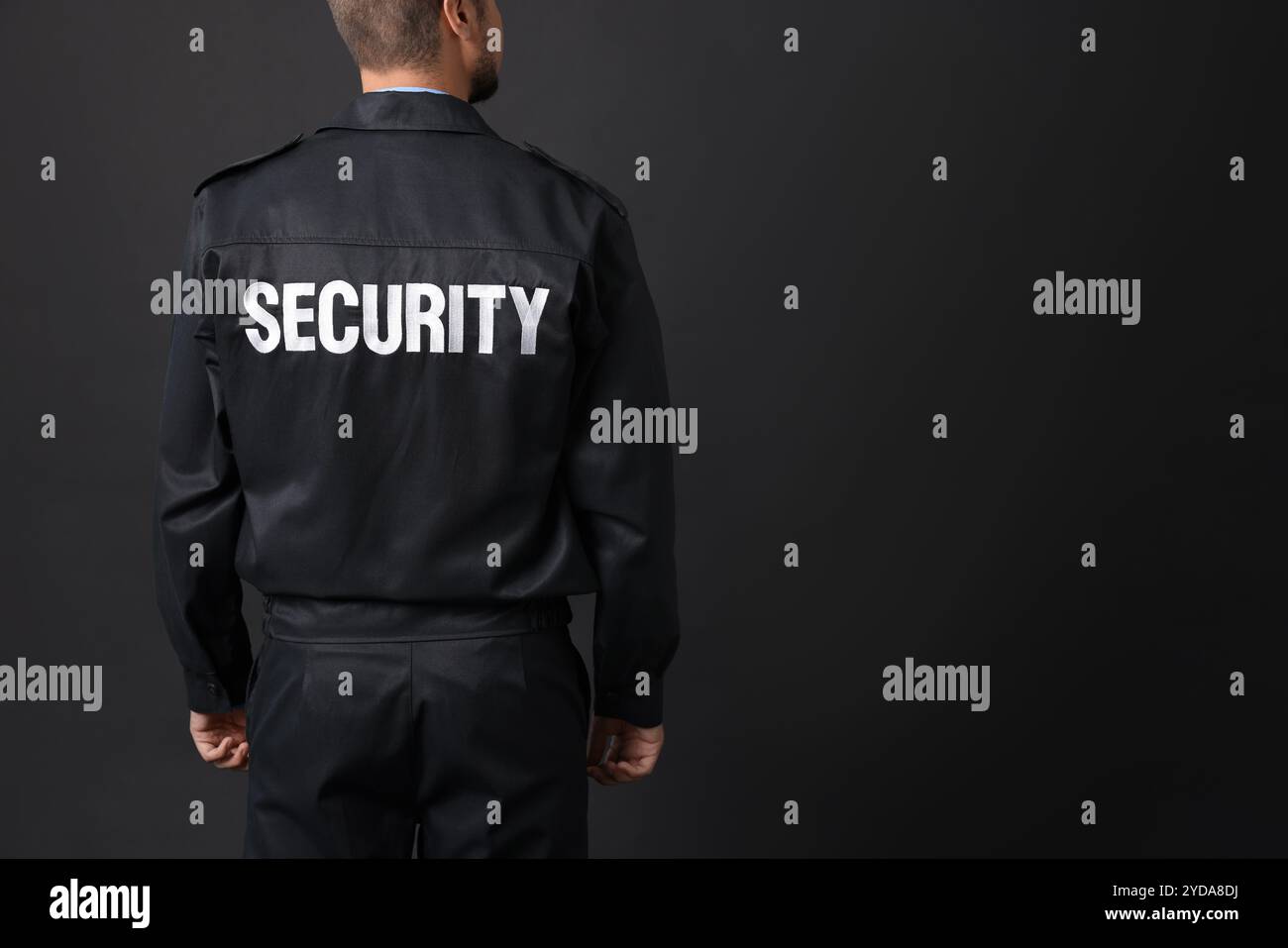 Security guard in uniform on black background, closeup. Space for text ...