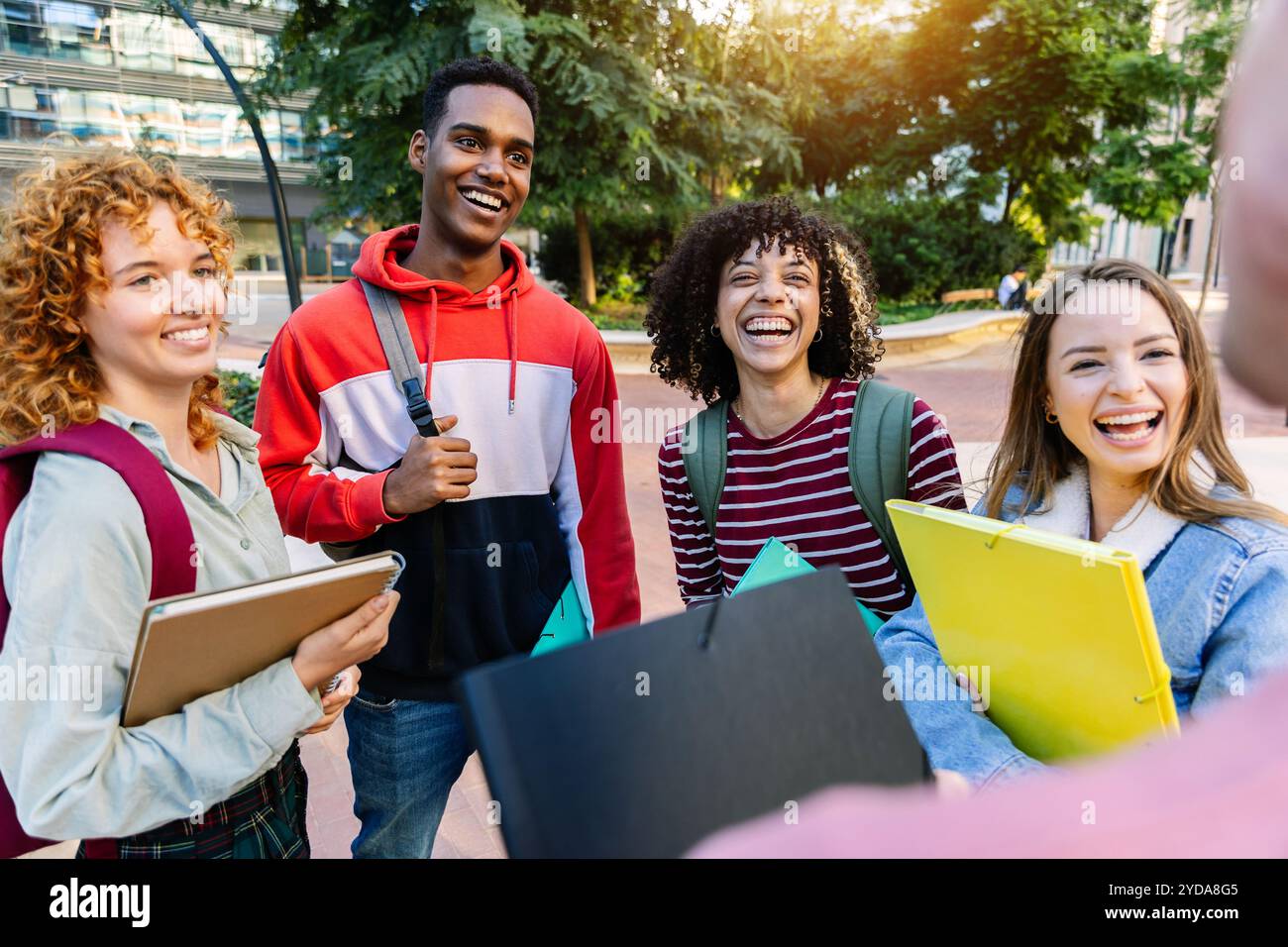 Happy young college students talking together on campus Stock Photo - Alamy