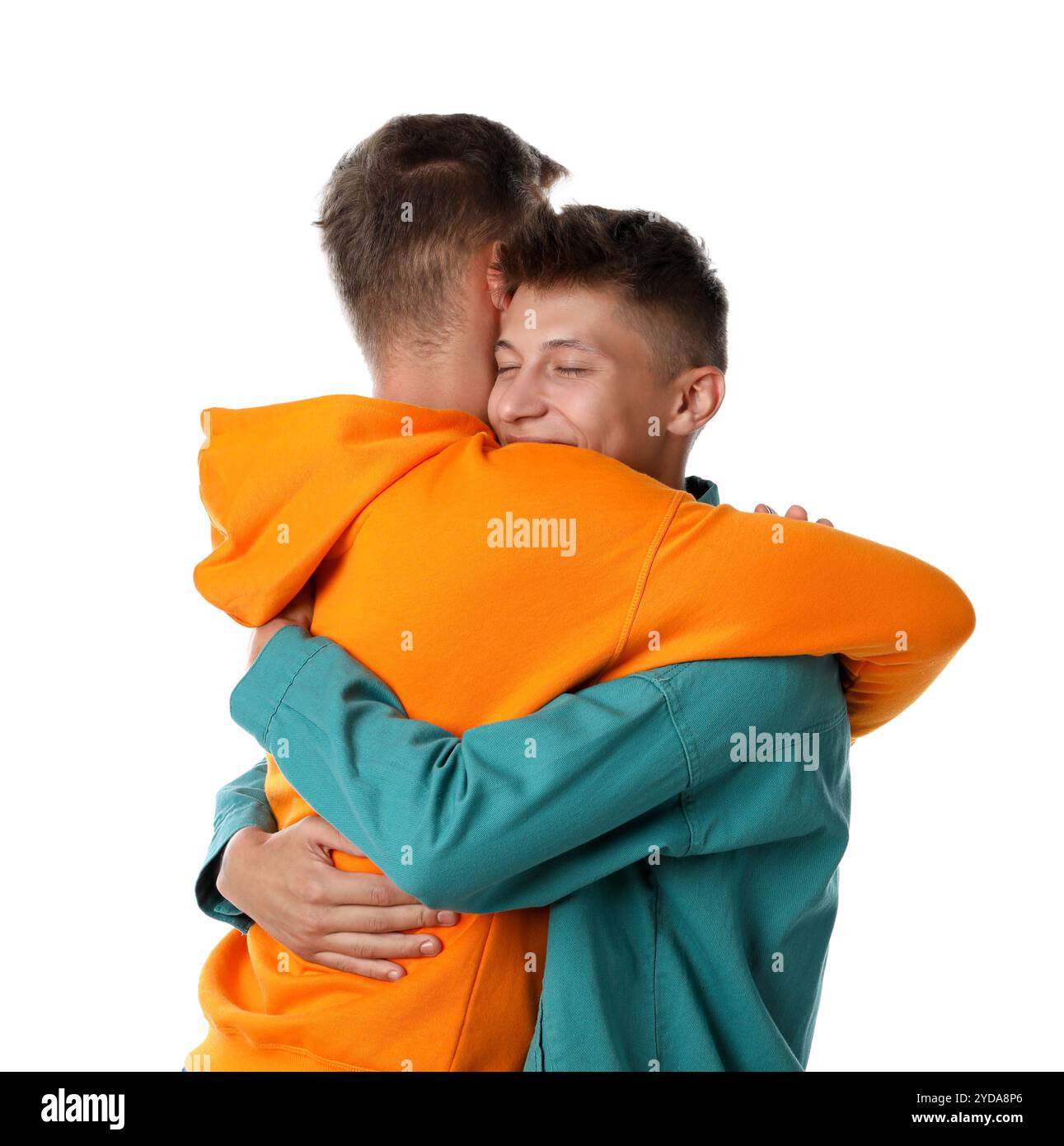 Two young brothers hugging on white background Stock Photo - Alamy