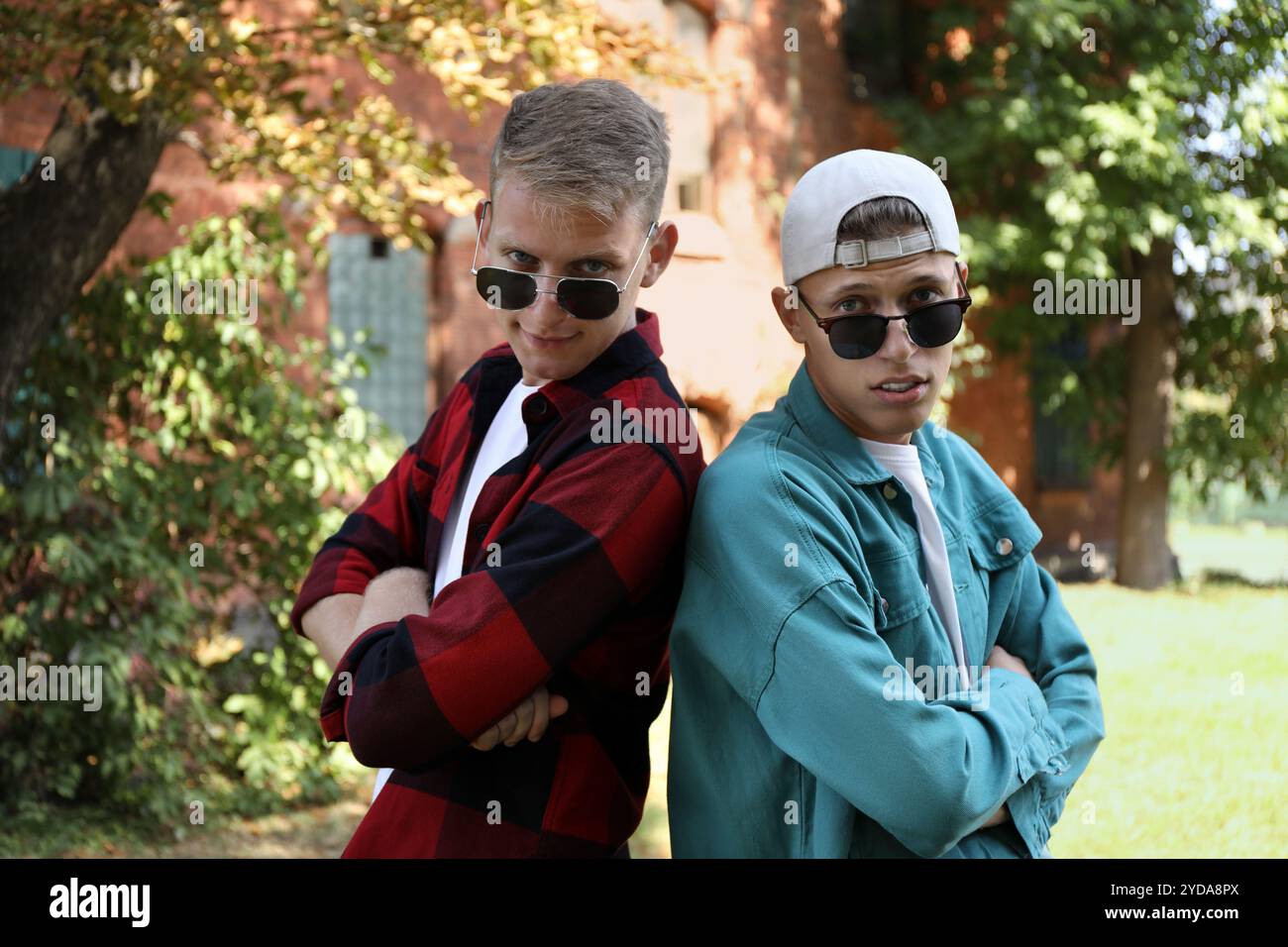 Family portrait of handsome brothers with crossed arms outdoors Stock ...