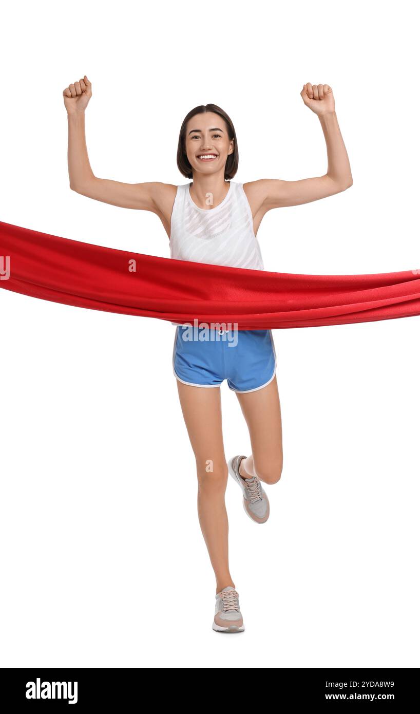 Beautiful woman in sportswear crossing red finish line on white ...