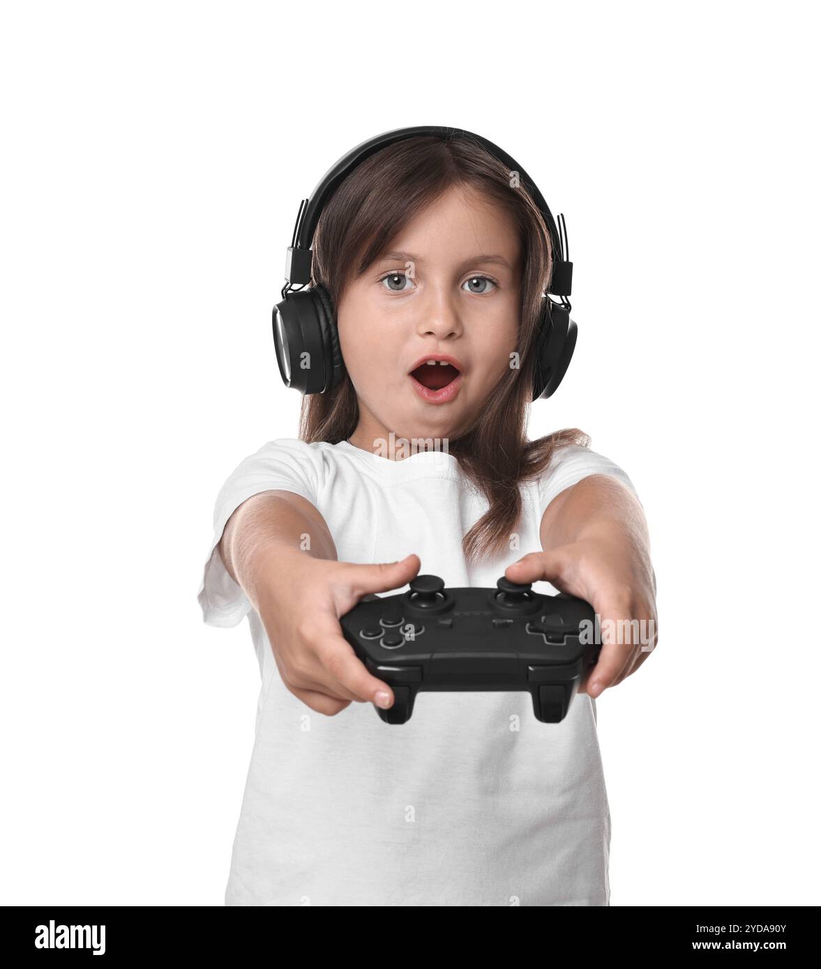Cute little girl in headphones playing video game with controller on ...