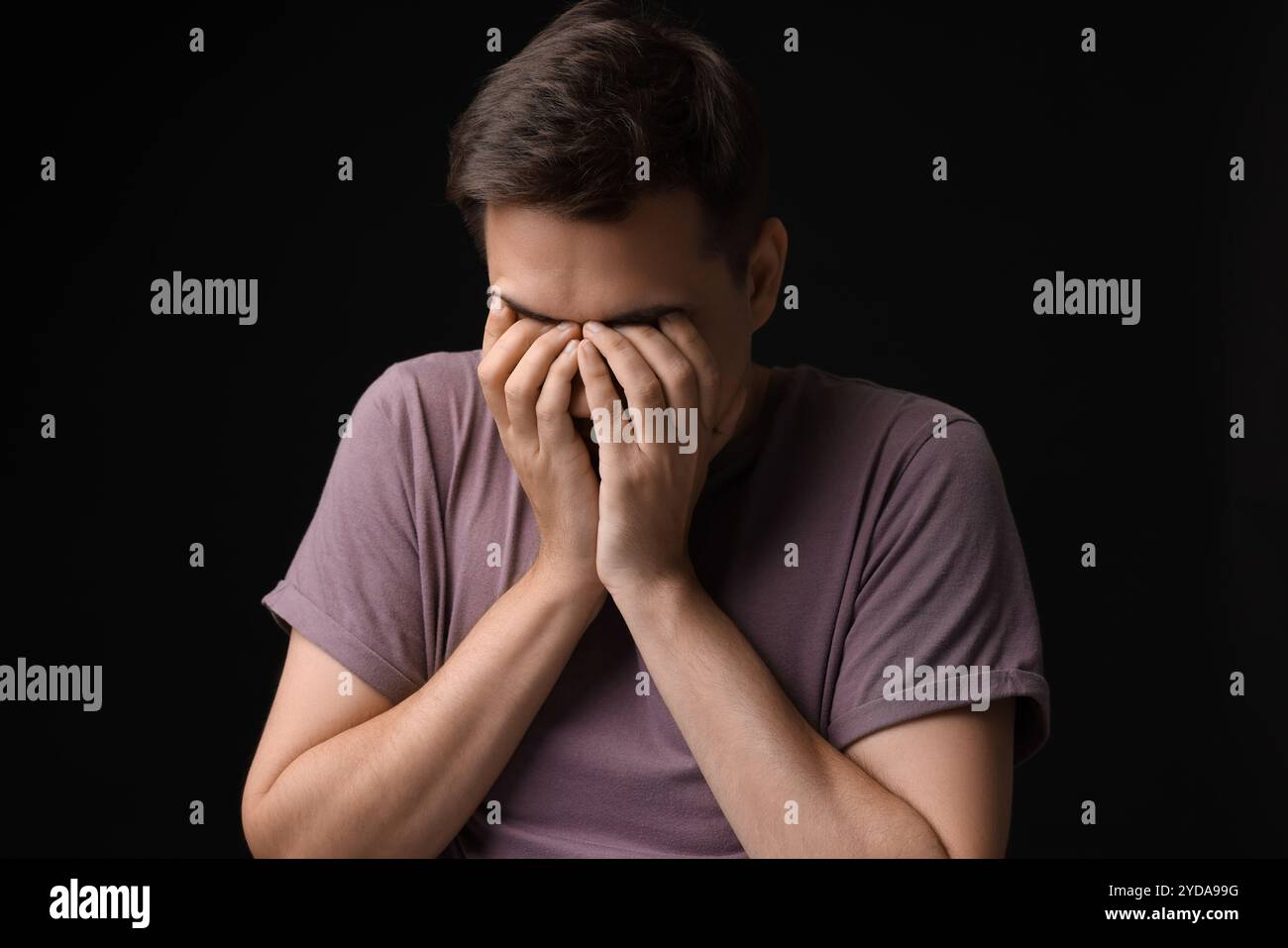 Shocked nervous young man hiding hi-res stock photography and images ...