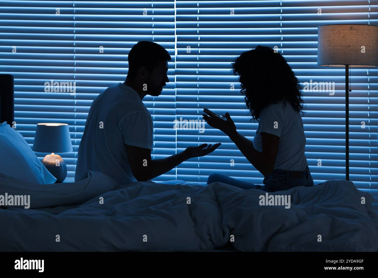 Emotional couple arguing in bedroom at night. Relationship problems ...