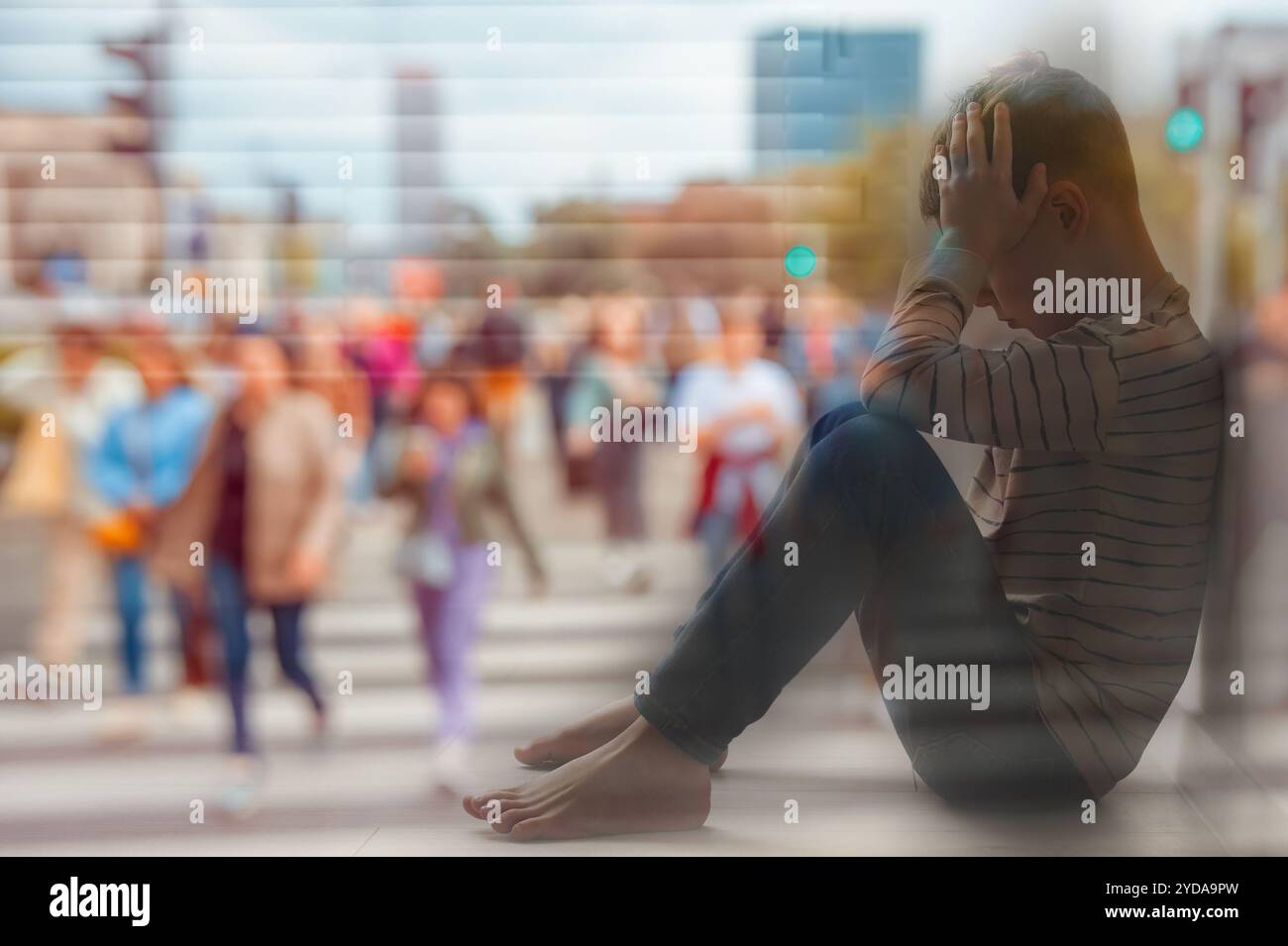 Loneliness. Sad boy sitting in room and crowded street, double exposure ...