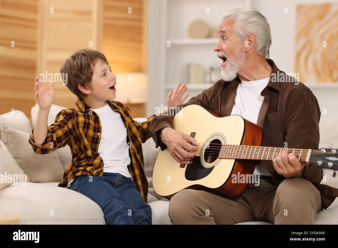 Grandpa teaching grandson play hi-res stock photography and images - Alamy